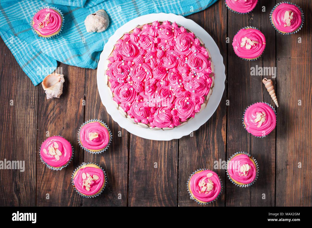 Cake and cupcakes with pink cream on rustic wood background. Pink cakes ...