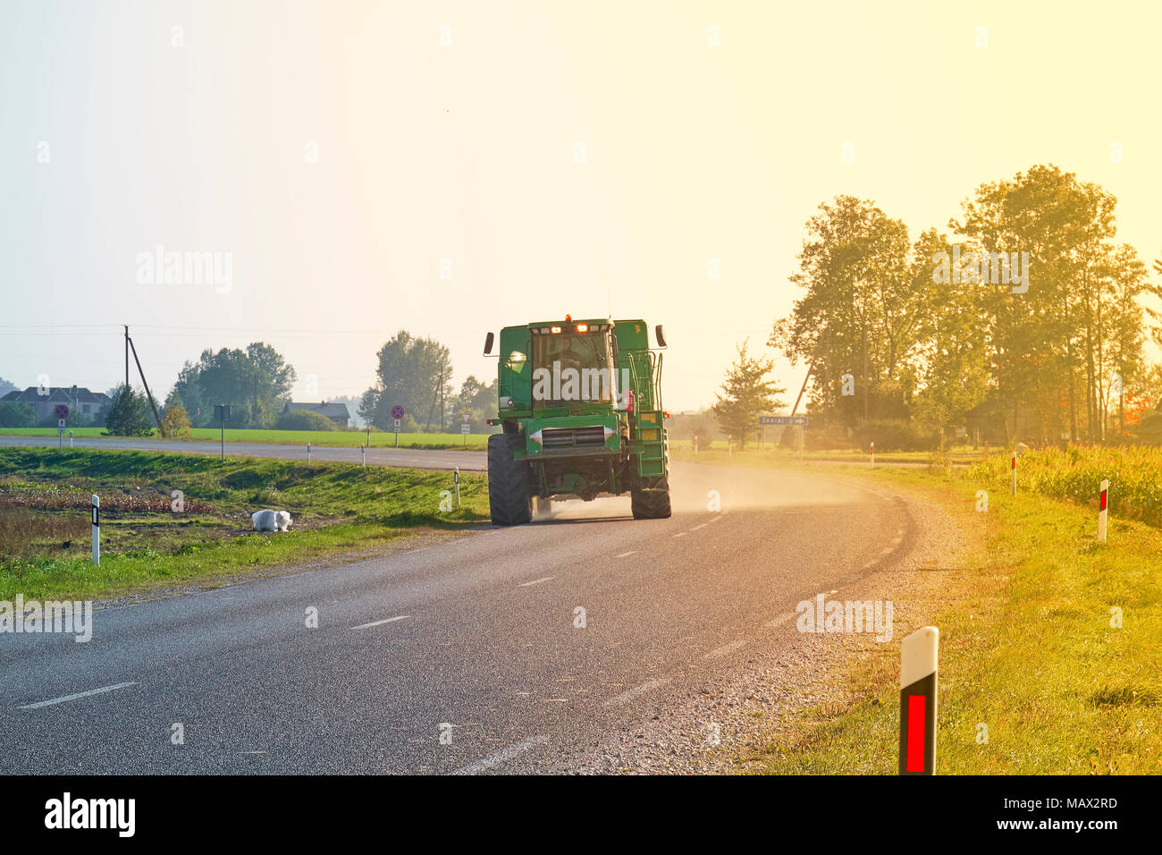 Farmer drives his tractor on the road hi-res stock photography and ...