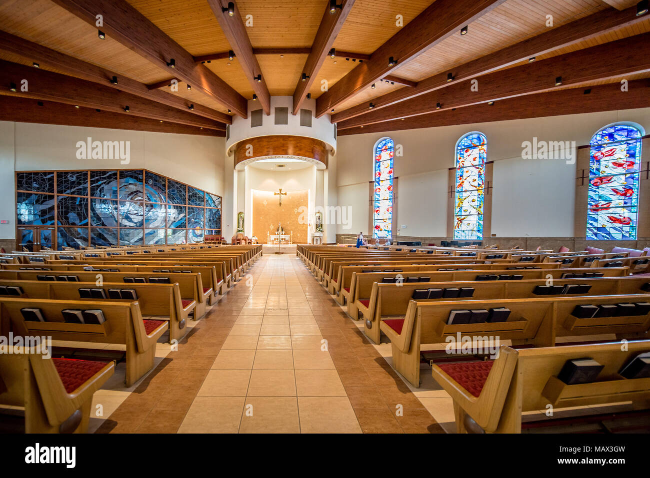 Empty catholic church with colorful stained-glass windows Stock Photo ...