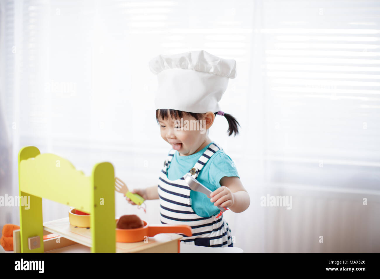 baby girl pretend play food toy Stock Photo - Alamy