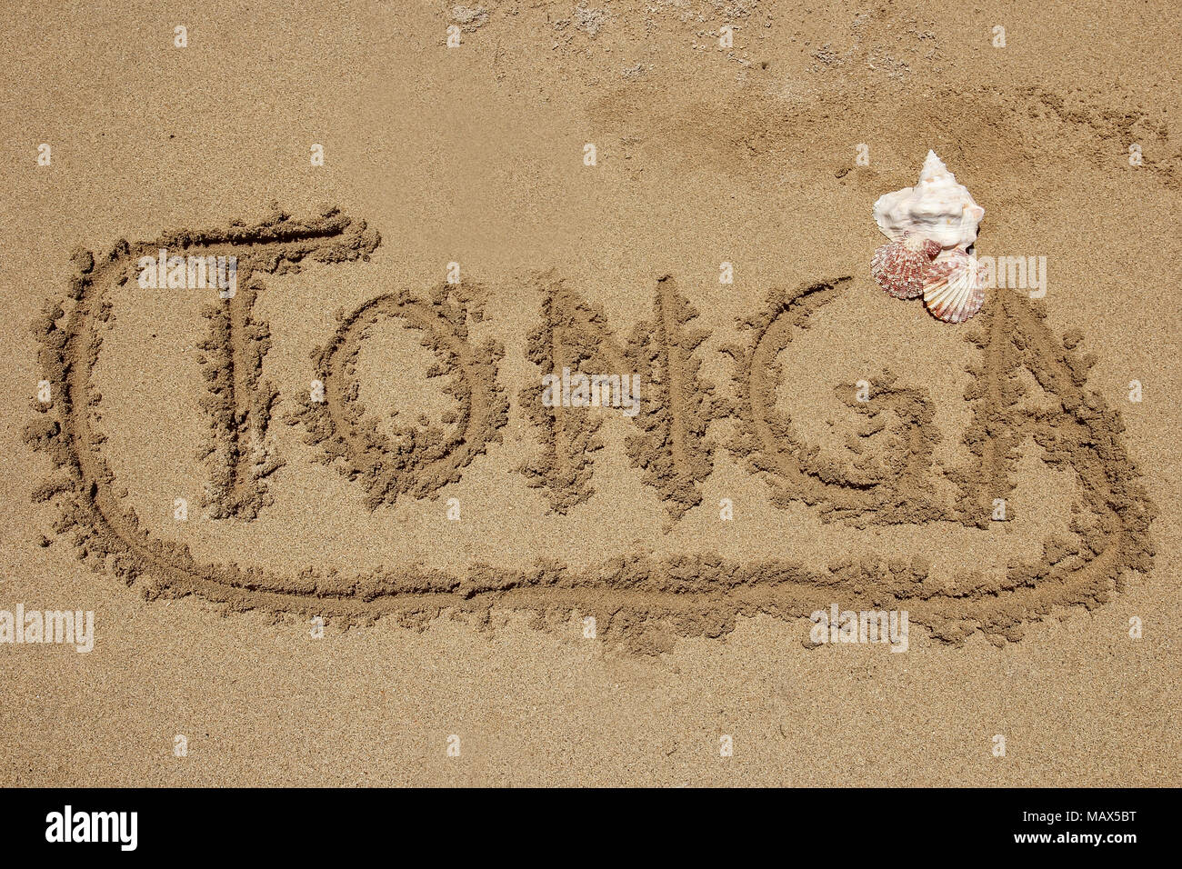 Word "Tonga" written in a sand - travel concept Stock Photo - Alamy