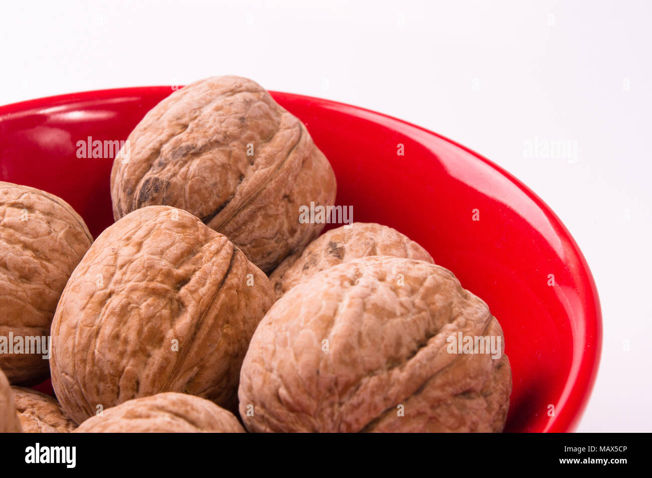 Walnuts in red plate hi-res stock photography and images - Alamy