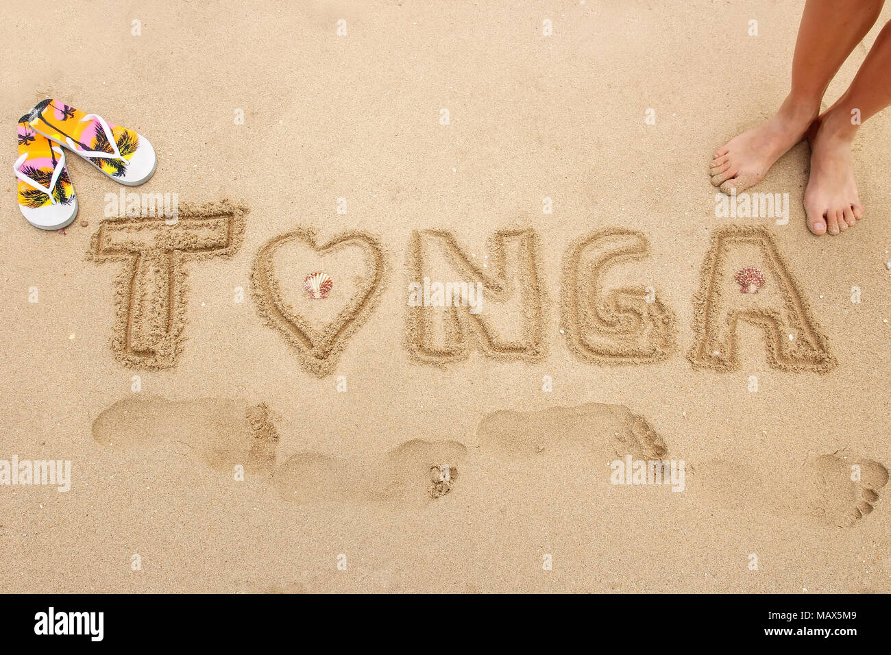Word "Tonga" written in a sand - travel concept Stock Photo - Alamy