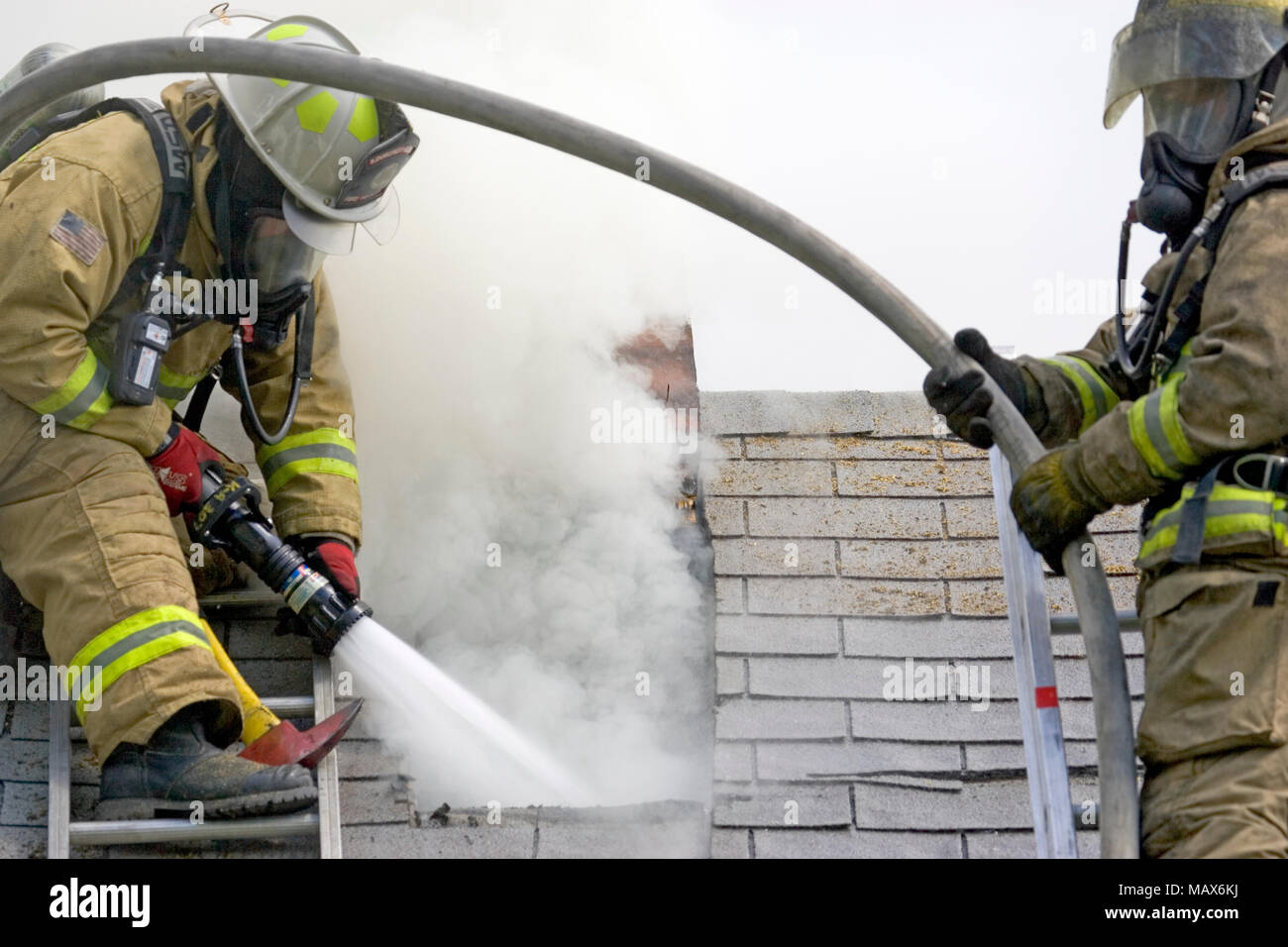 Firefighter on roof hi-res stock photography and images - Alamy