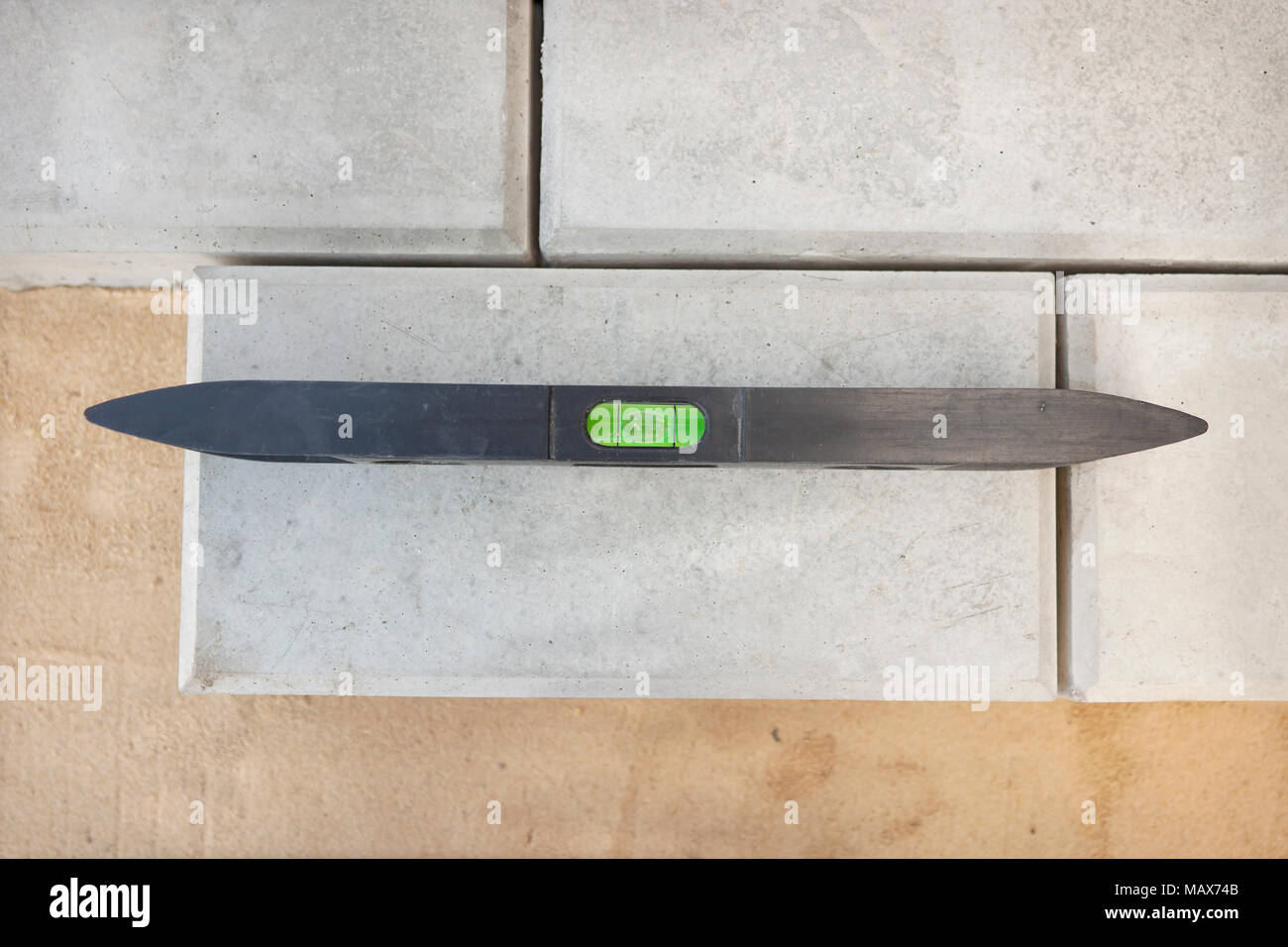 Level gauge always It is applied at stone blocks laying Stock Photo - Alamy