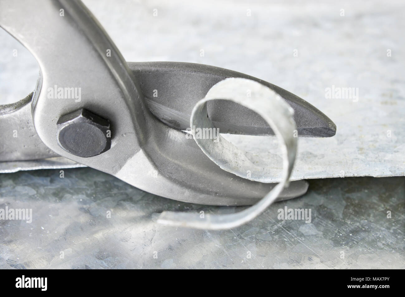 Sharp scissors cut the sheet metal into strips Stock Photo - Alamy