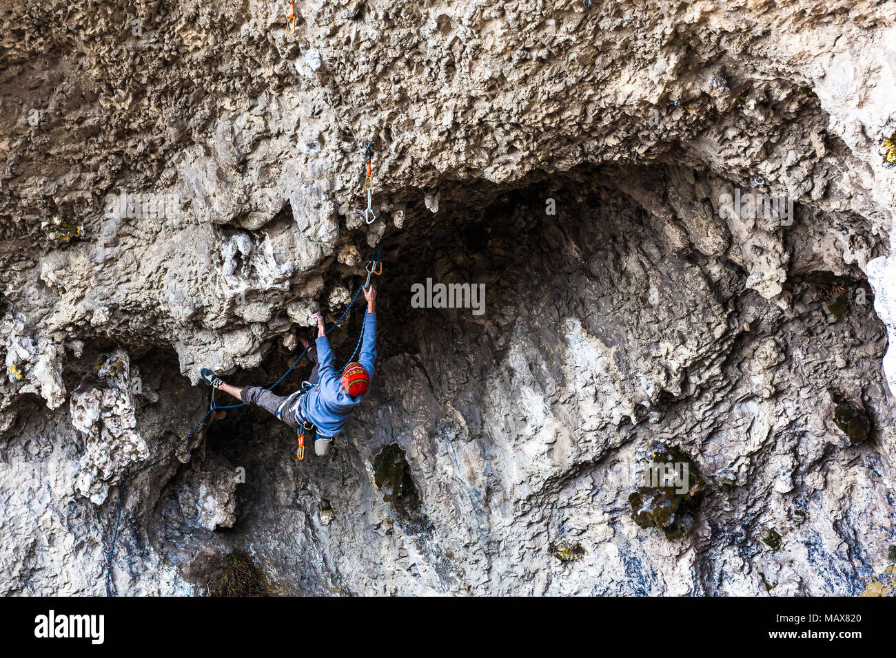 Young climber climbing the rock walls of a cave, Ecuador Stock Photo ...