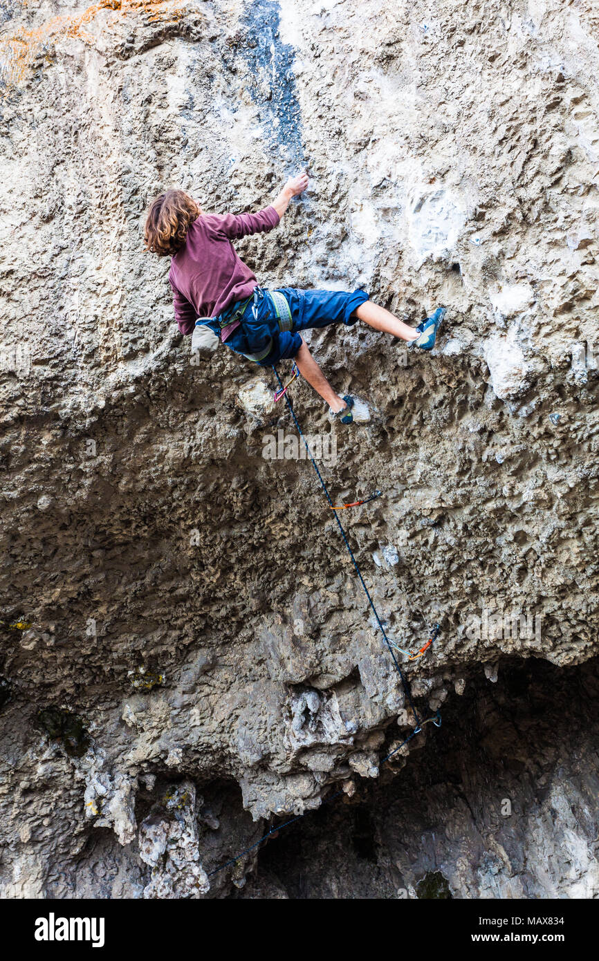 Young climber climbing the rock walls of a cave, Ecuador Stock Photo ...