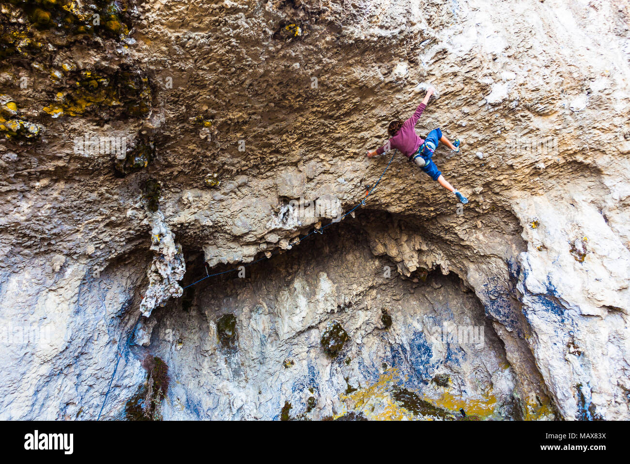 Young climber climbing the rock walls of a cave, Ecuador Stock Photo ...