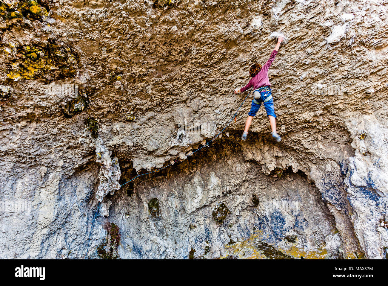 Young climber climbing the rock walls of a cave, Ecuador Stock Photo ...
