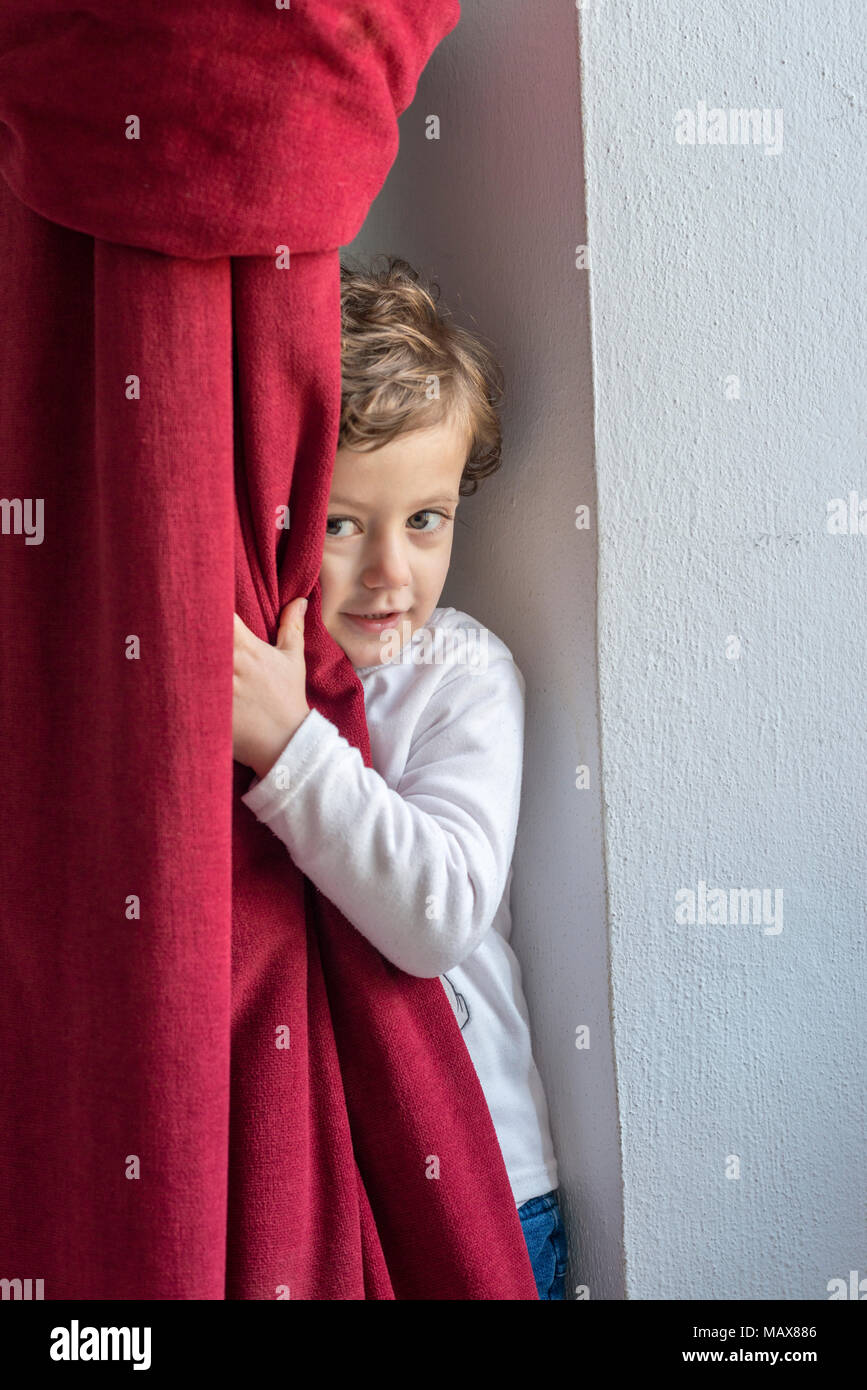 Child hiding behind curtain hi-res stock photography and images - Alamy