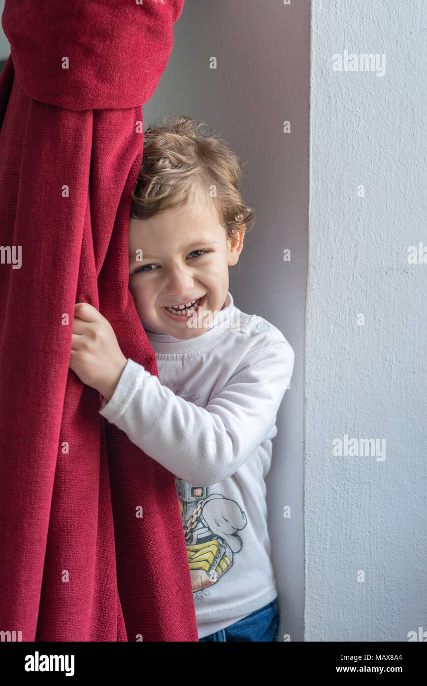 Child hiding behind curtain hi-res stock photography and images - Alamy