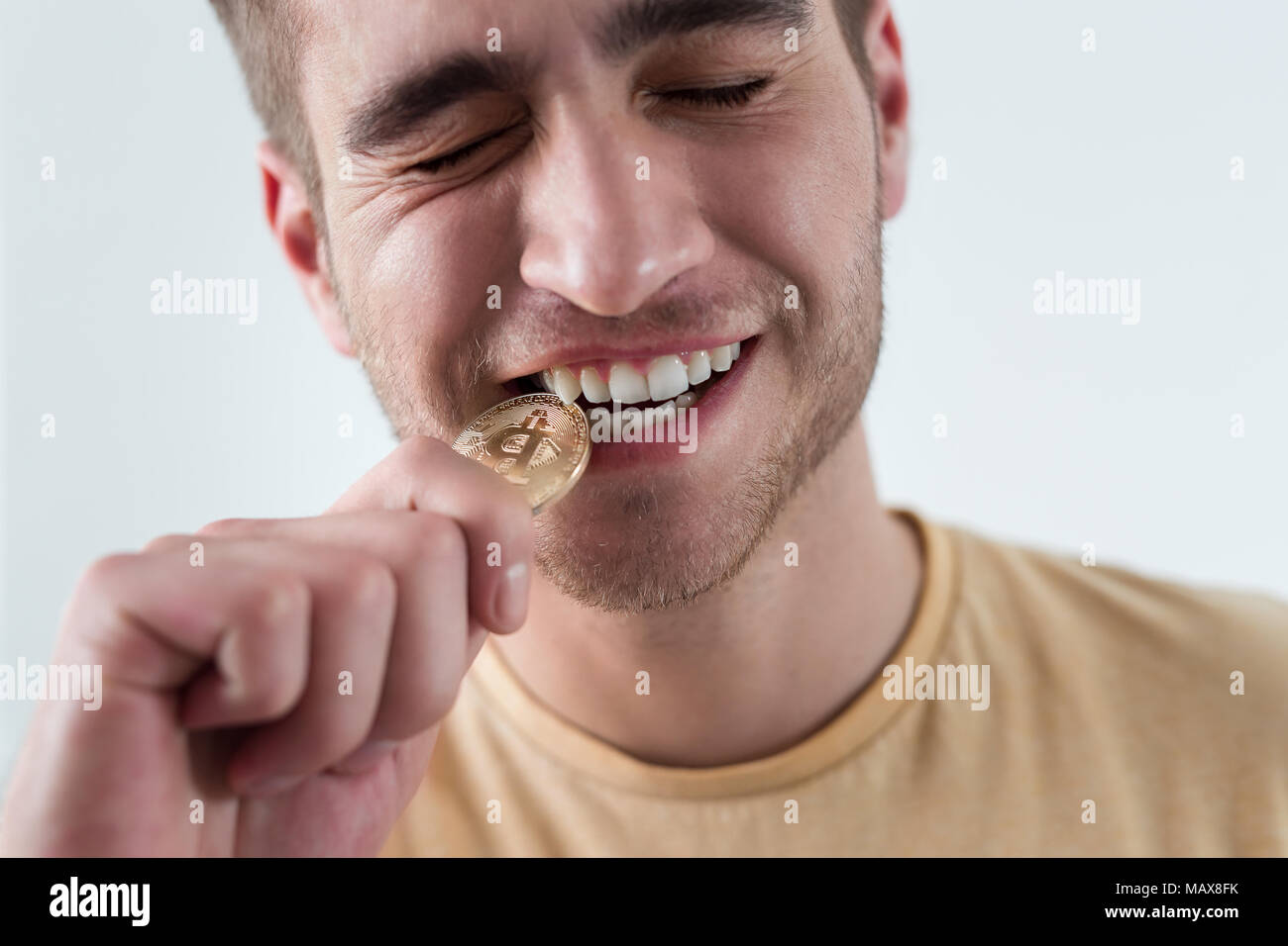 Biting gold coin bitcoin hi-res stock photography and images - Alamy