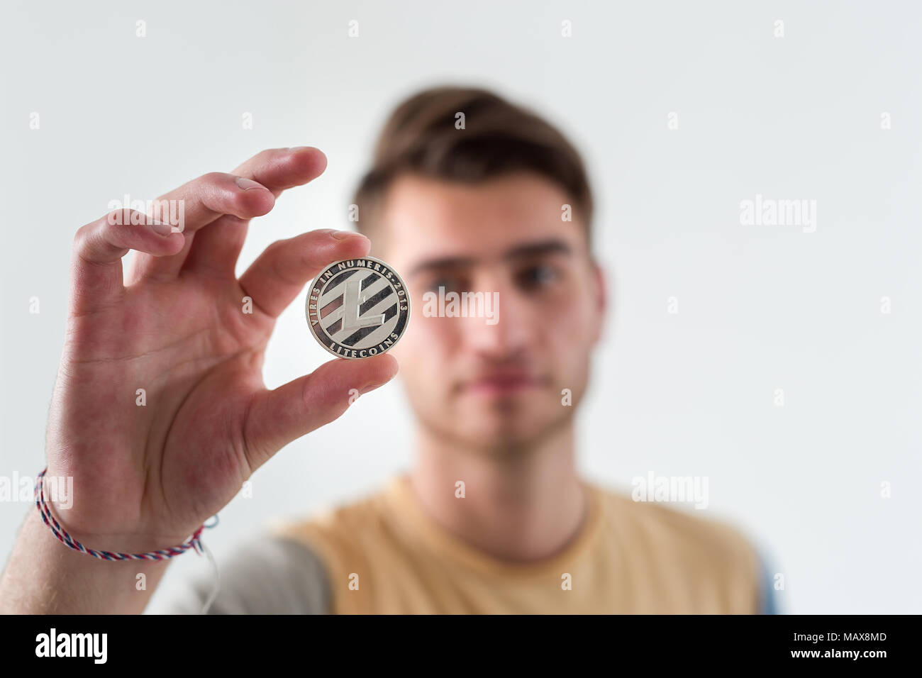 Man holding an crypto currency coin in his hand. Various types series ...