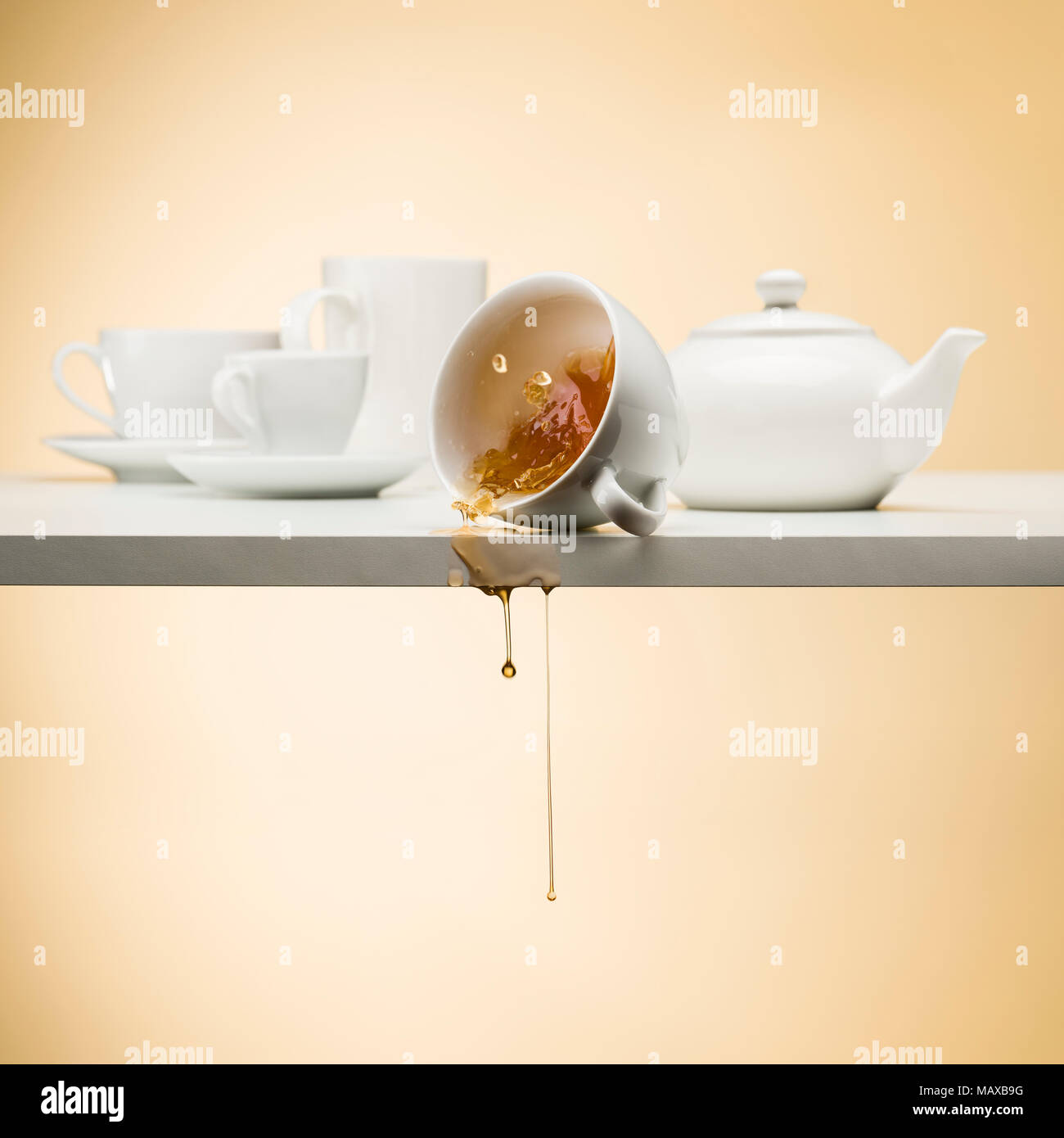 falling cup of tea dripping from white table Stock Photo - Alamy