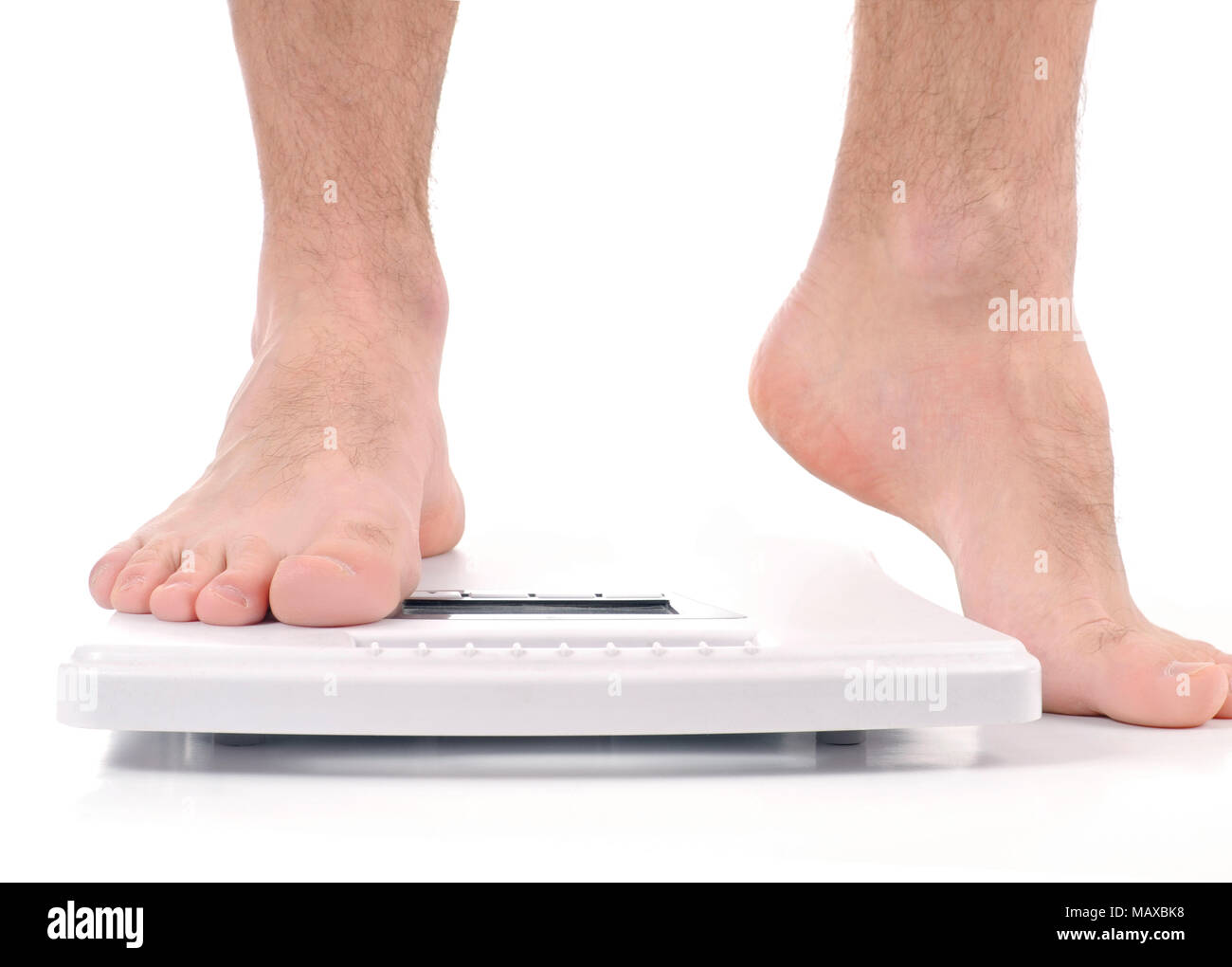 Diet concept. Man standing on weight scale Stock Photo - Alamy