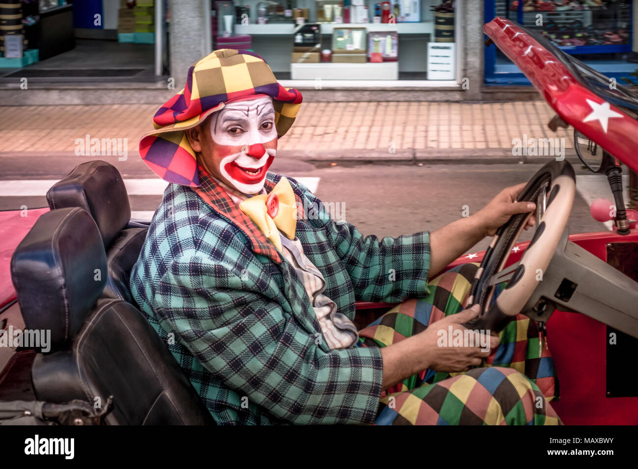 Benidorm circus artists driving car in Benidorm street Stock Photo - Alamy