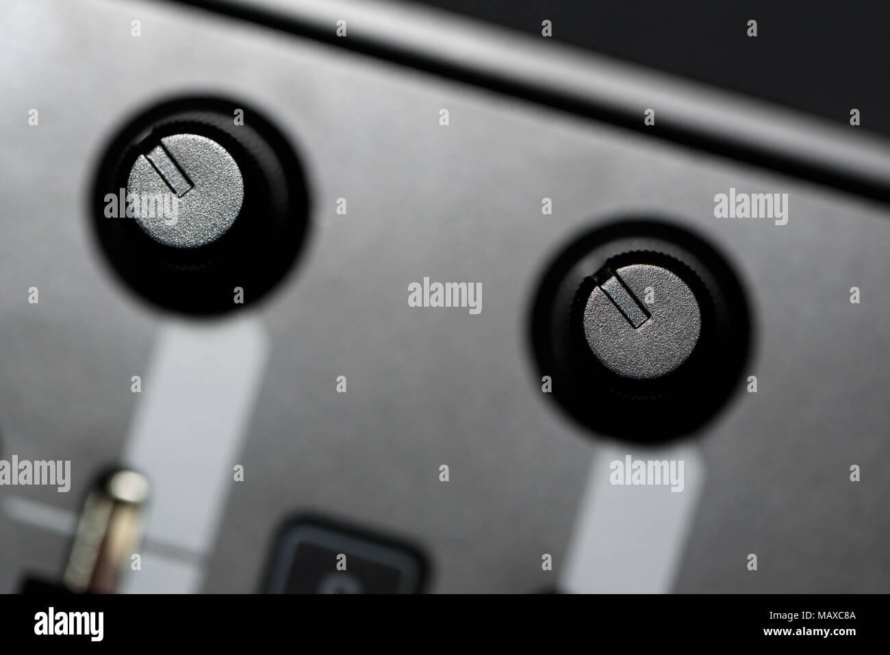 Macro close up of audio studio mixer volume level sliders and dials ...