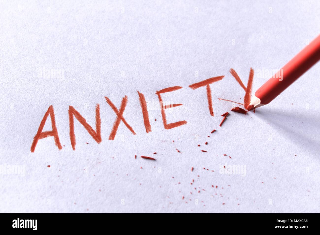 Anxiety concept. Word anxiety written on white paper with red pencil ...
