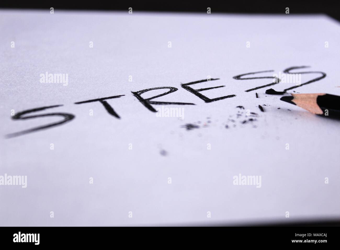 Stress Concept. Word stress written on white paper with black broken ...