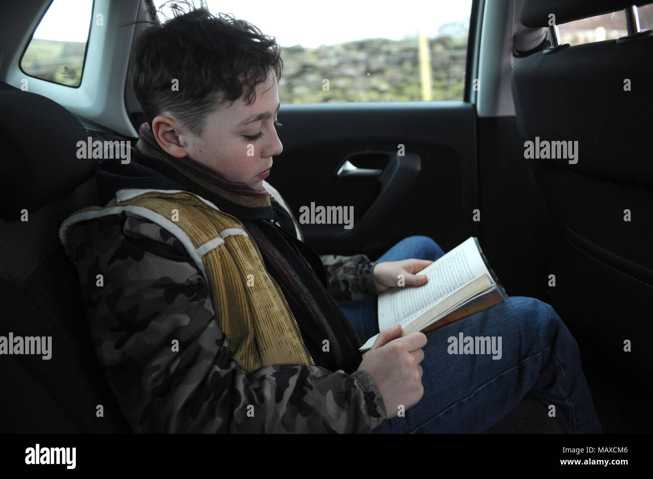 Teenager Reading On A Car Journey In North Yorkshire Stock Photo Alamy teenager-reading-on-a-car-journey-in-north-yorkshire-stock-photo-alamy