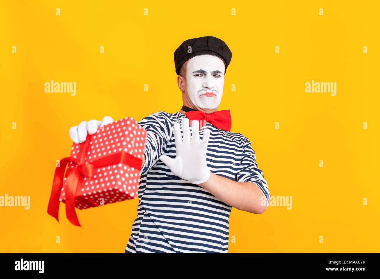 Mime man holding bad gift, he do not need it. Emotions and feelings ...