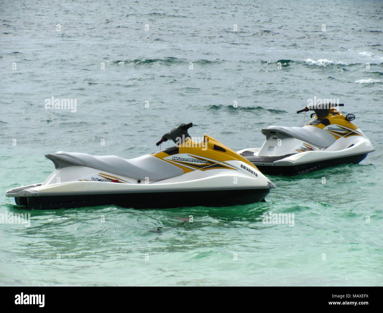Pair of water jets on a Bahama beach shoreline Stock Photo - Alamy