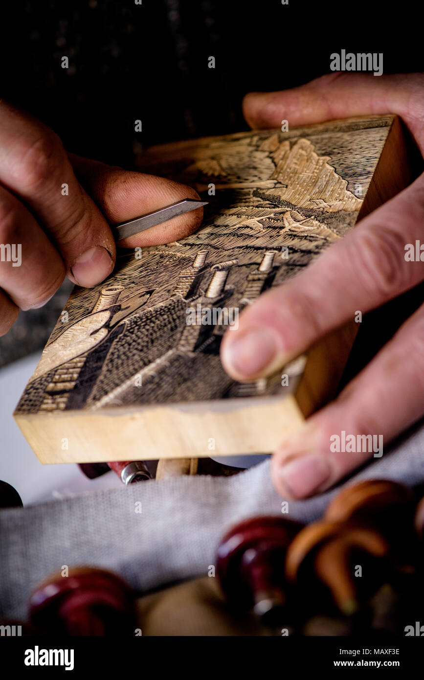 Craftsman Keith Pettit working on one of his wood engravings depicting ...