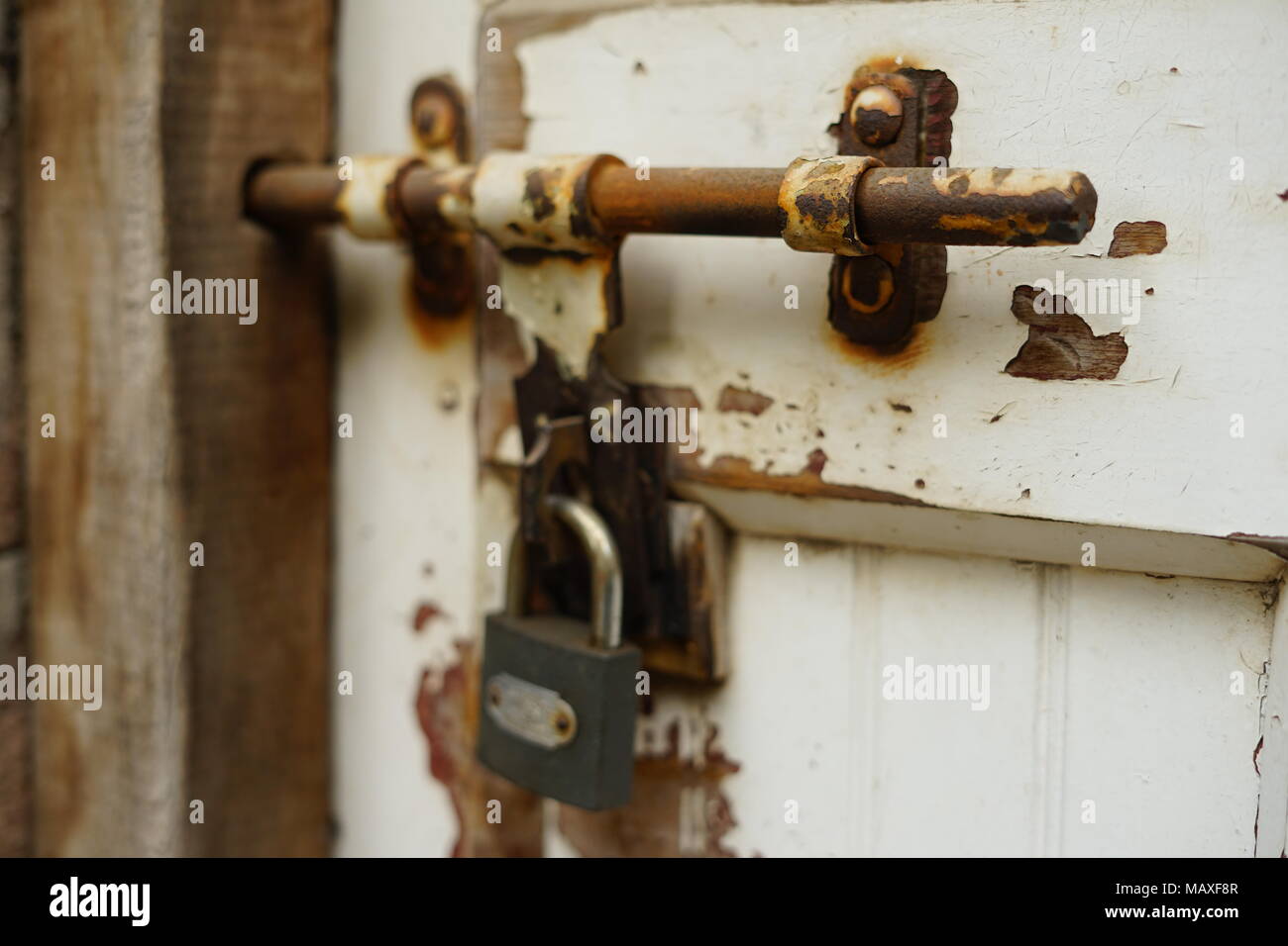 A rusted door bolt locked in a rural village home Stock Photo - Alamy
