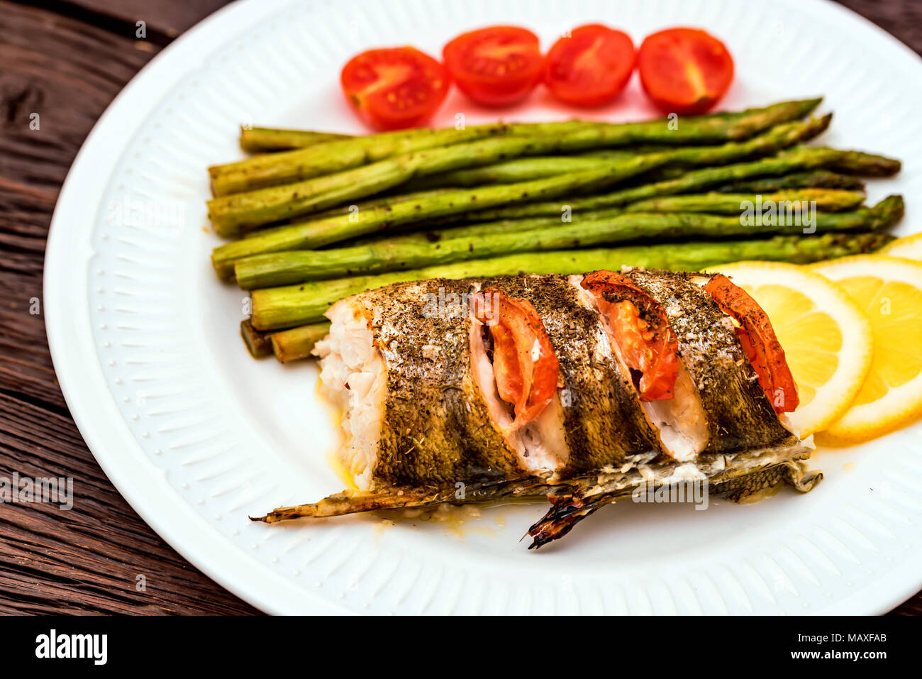 Roasted zander fillet with asparagus and lemon Stock Photo - Alamy
