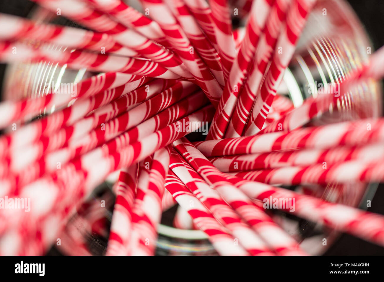 Red And White Sticks in Jar appear to be swirling Stock Photo - Alamy