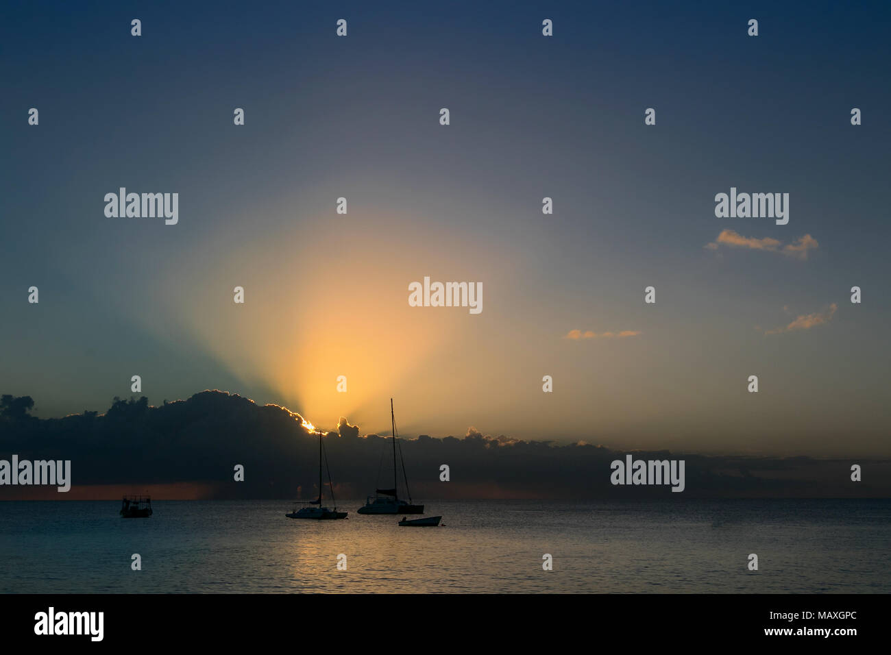 Ocean sunset with boats Stock Photo - Alamy