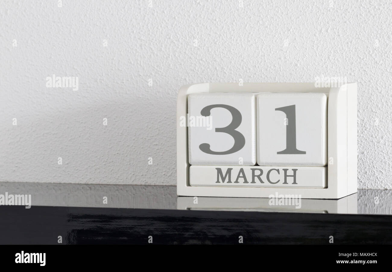 White block calendar present date 31 and month March on white wall ...