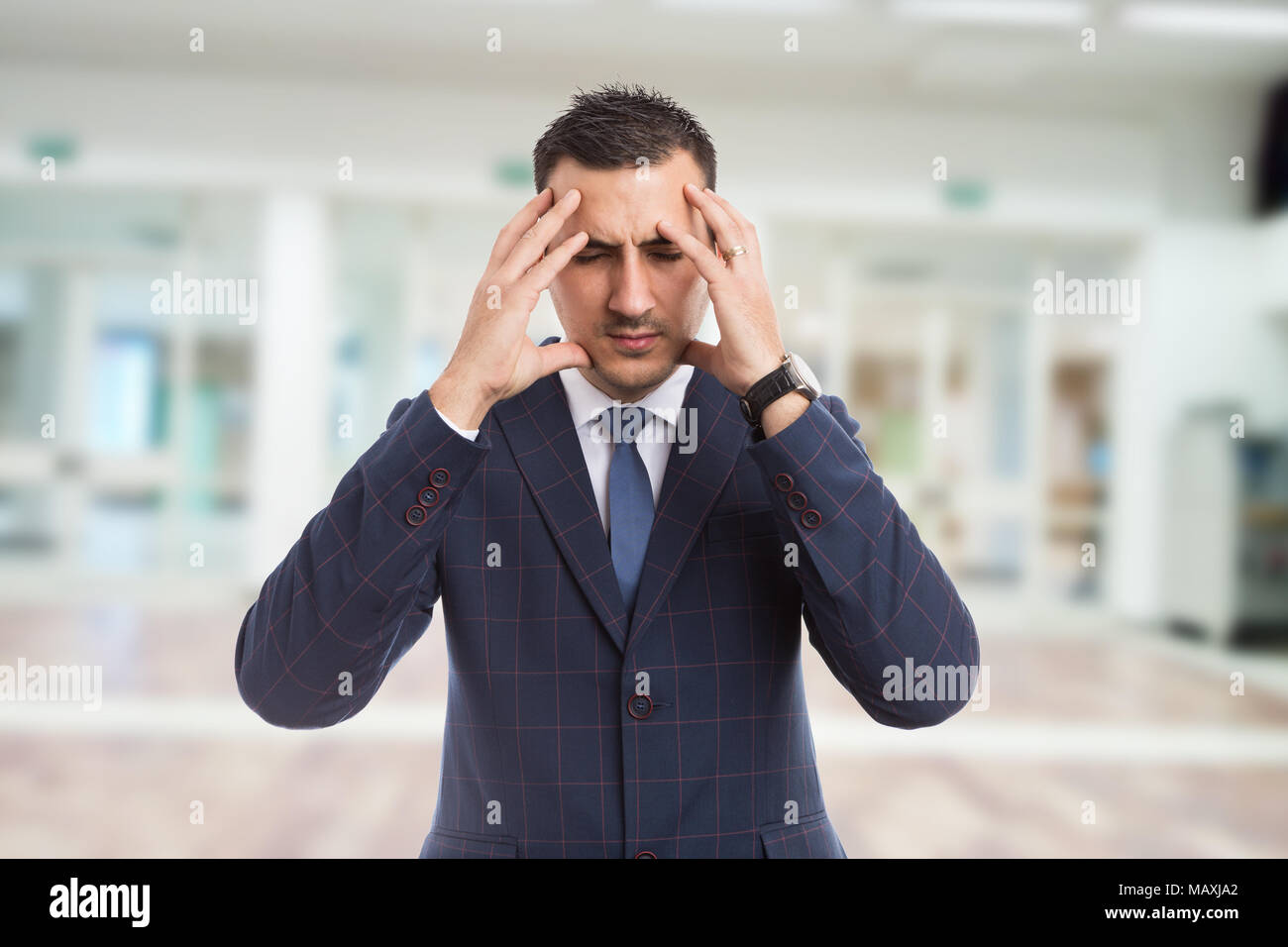 Real estate agent or realtor suffering headache migraine pressing head ...
