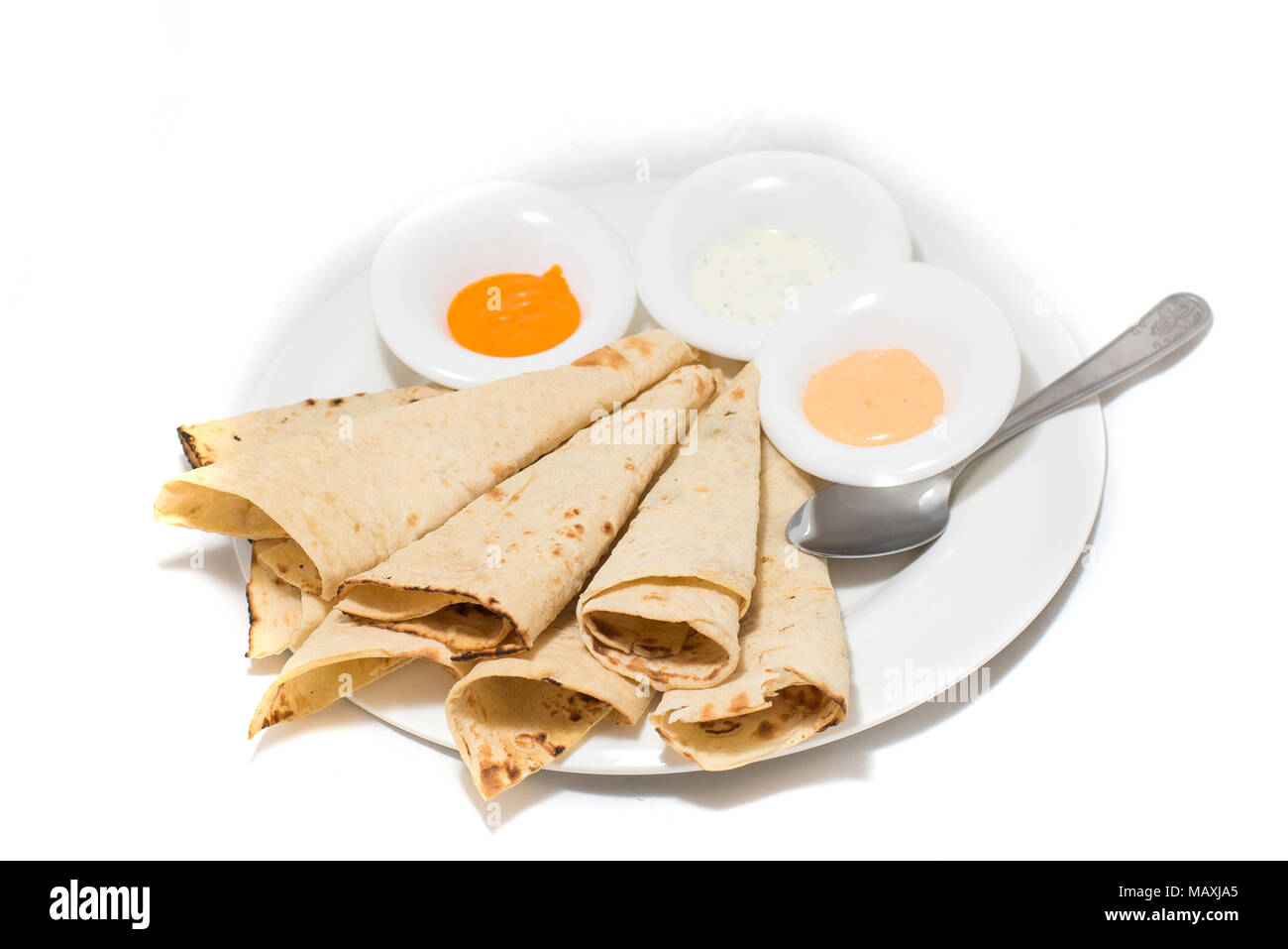 Bread round thin white with sauce on a white plate white background ...