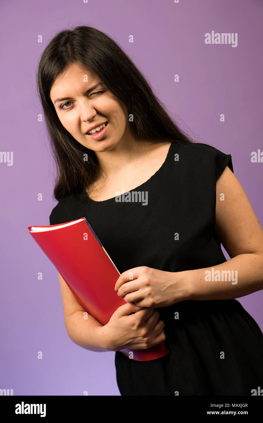 Young Woman in Black Dress with Red Notebook on Purple Background ...
