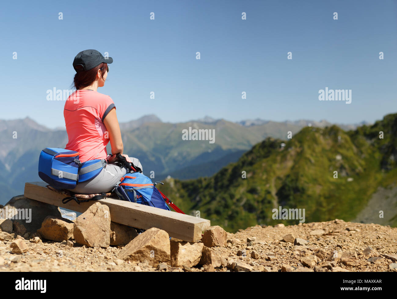 Image from back of girl with sticks for sporty walk Stock Photo - Alamy