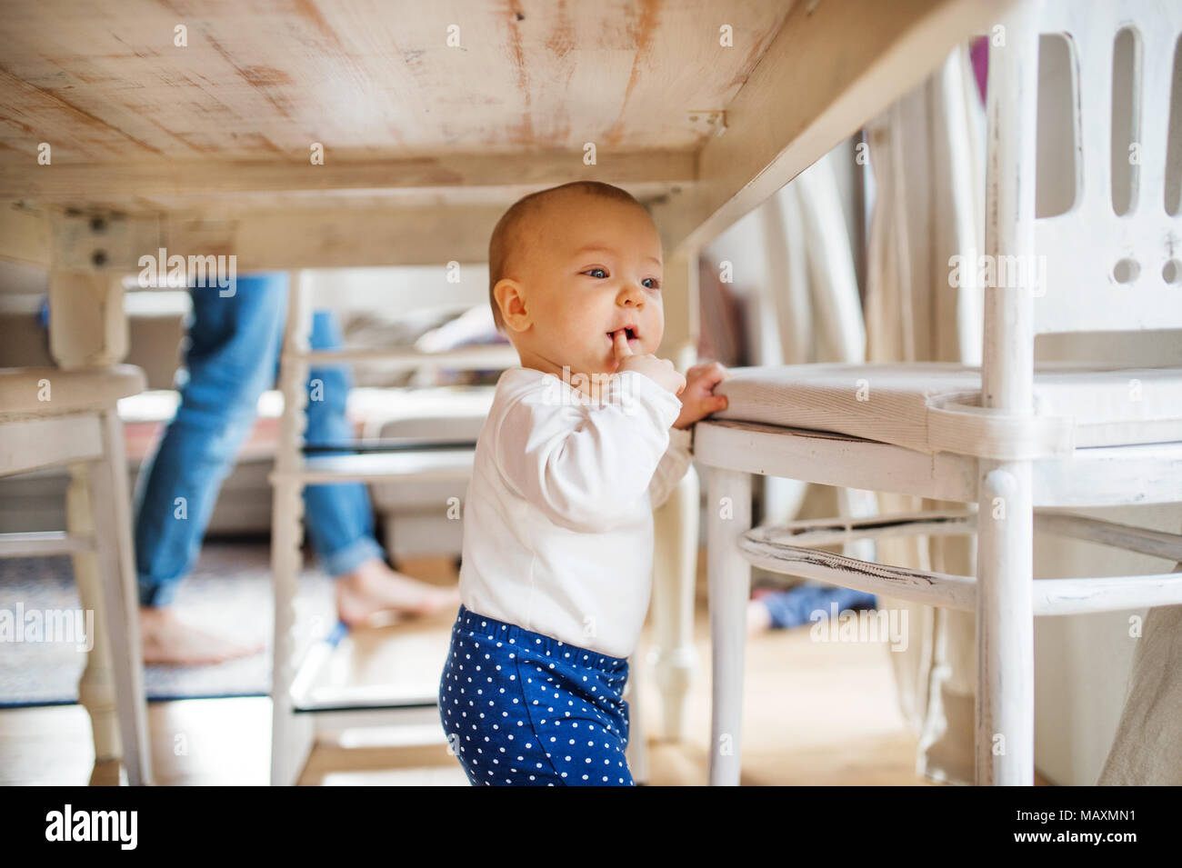 Baby looking under table hi-res stock photography and images - Alamy