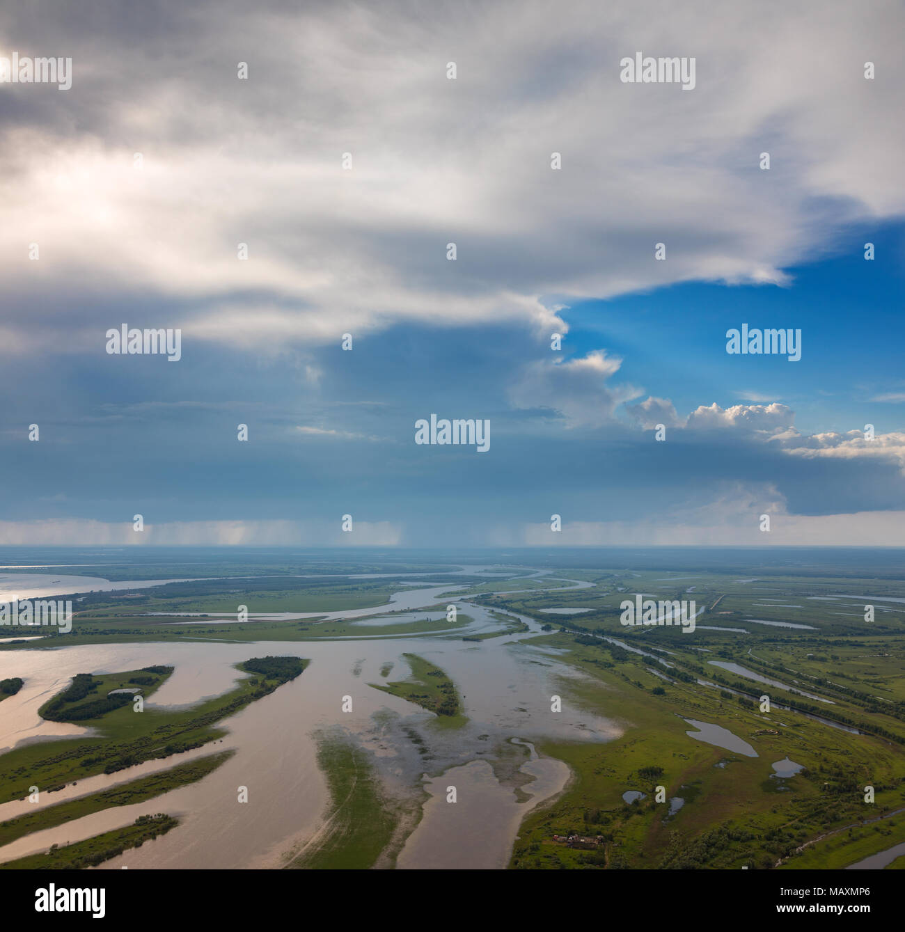 Rain comes from thunderclouds over the Great plain river in summer, the ...