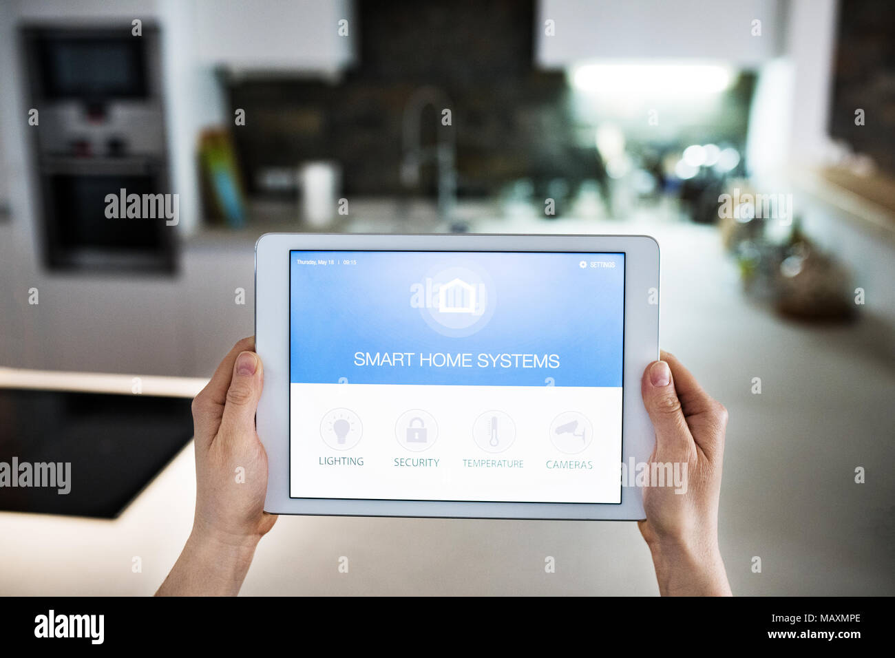 A woman holding a tablet with smart home screen Stock Photo - Alamy
