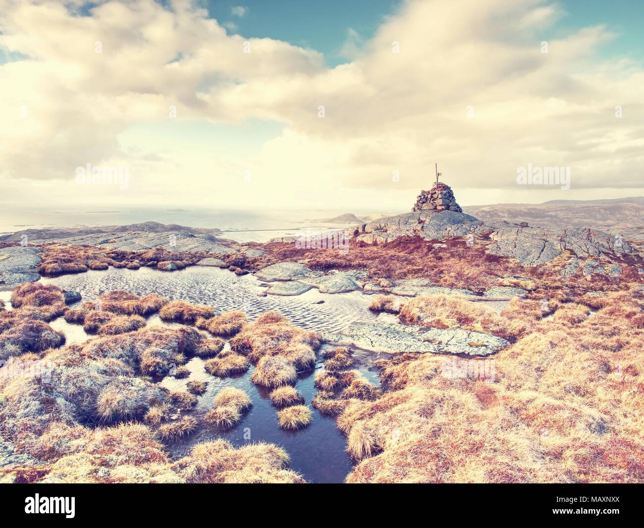 Narrow mountain path ends at peak mound, pyramid built of stone. Stony ...