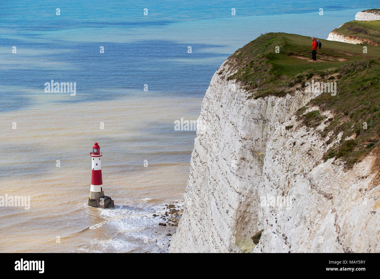 Man Peering Over the Cliffs above Beachy Head Lighthouse, a Spot ...