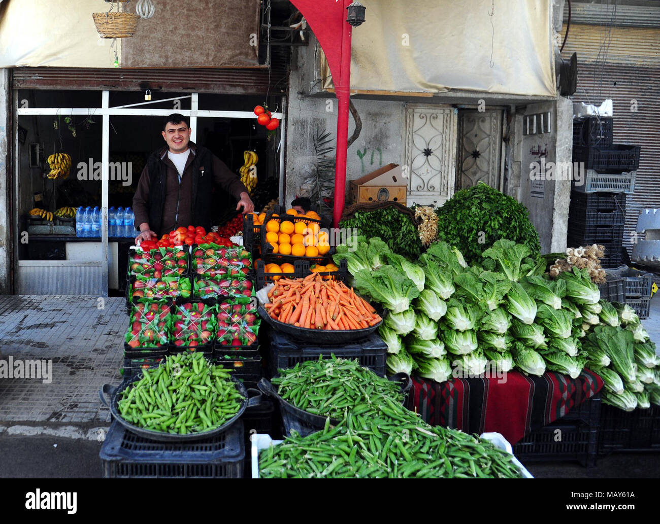 Eastern Ghouta, Syria. 5th Apr, 2018. A greengrocer arranges vegetables ...