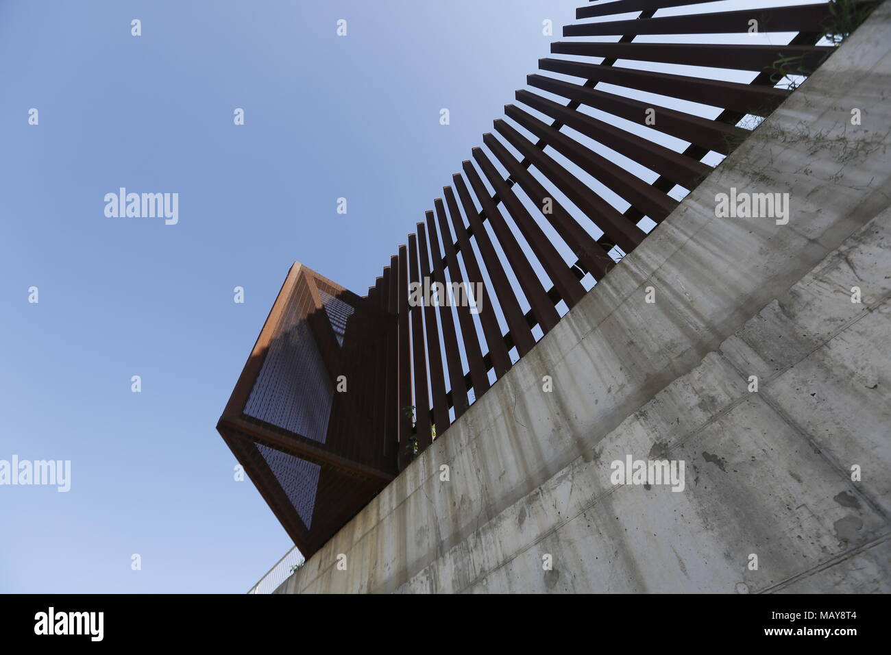 Steel bollard can be seen atop a concrete wall as it lines the banks of ...