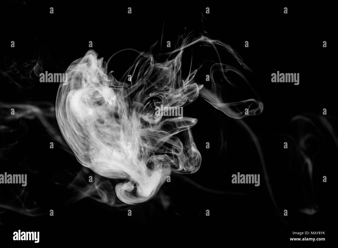 Thick white smoke on a black isolated background. Background from the ...