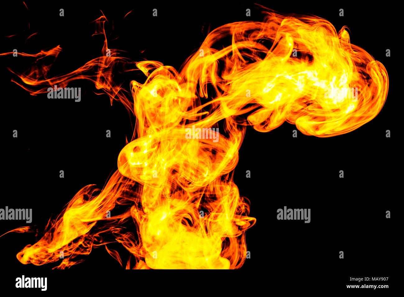 Thick fiary smoke on a black isolated background. Fire flames ...