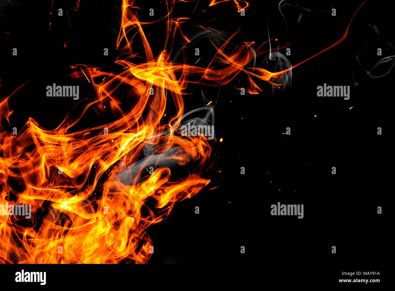 Dense fiery flames smoke on a black isolated background. Background of ...
