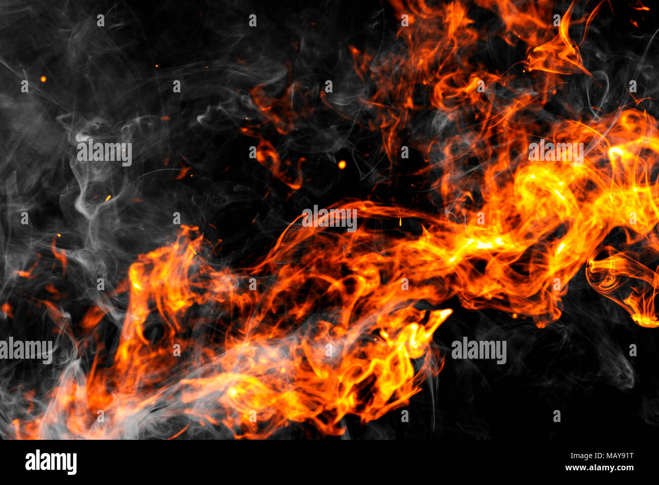Dense fiery flames smoke on a black isolated background. Background of ...