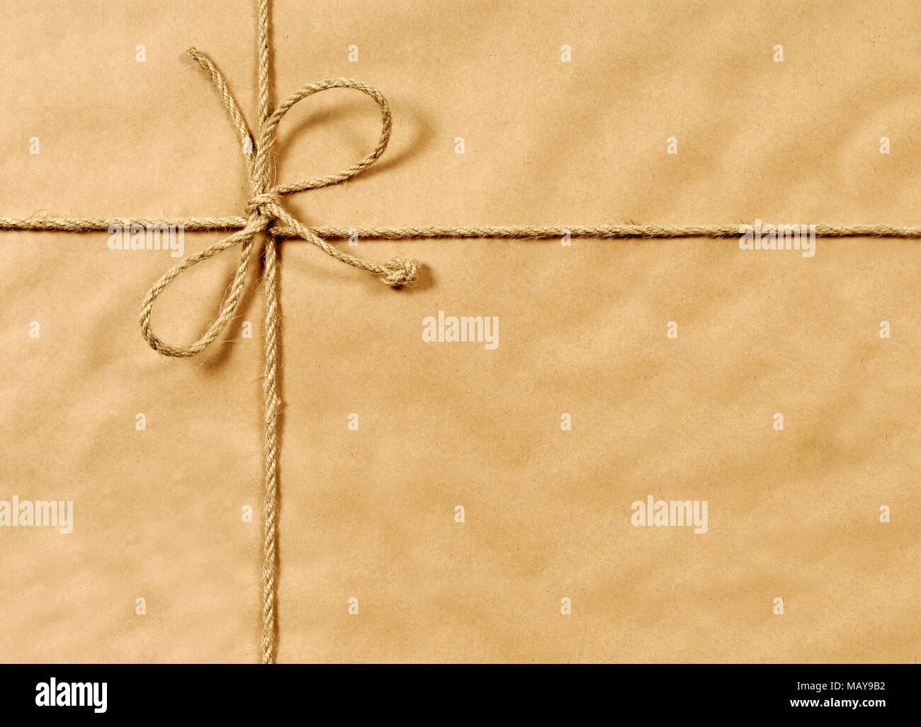 Brown paper parcel background with string and copyspace Stock Photo - Alamy