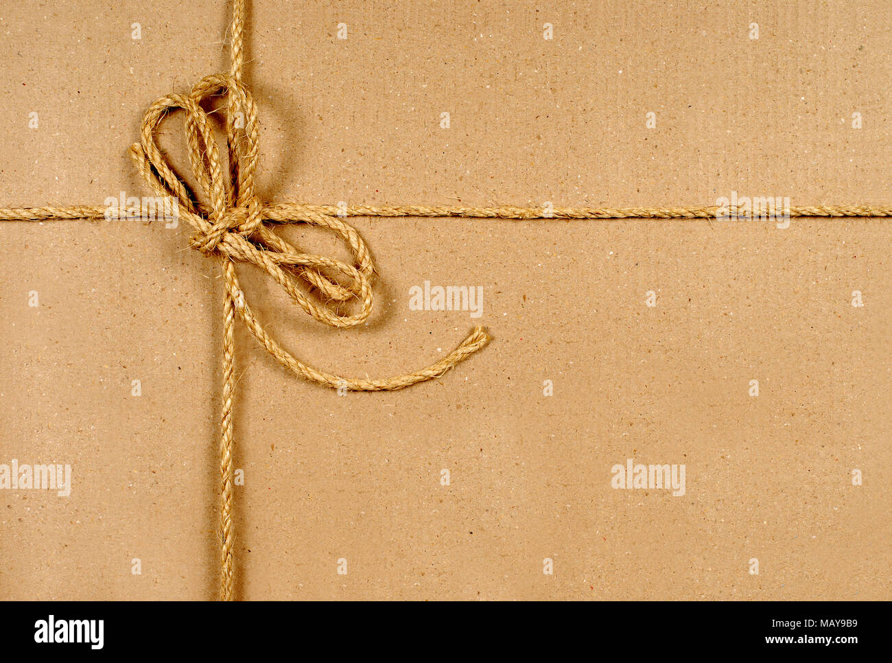 Brown paper parcel background with string and copyspace Stock Photo - Alamy